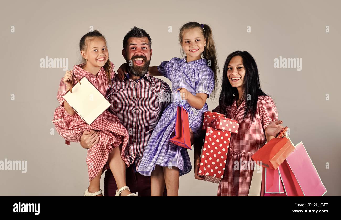 happy family go shopping together hold packages, sales Stock Photo - Alamy