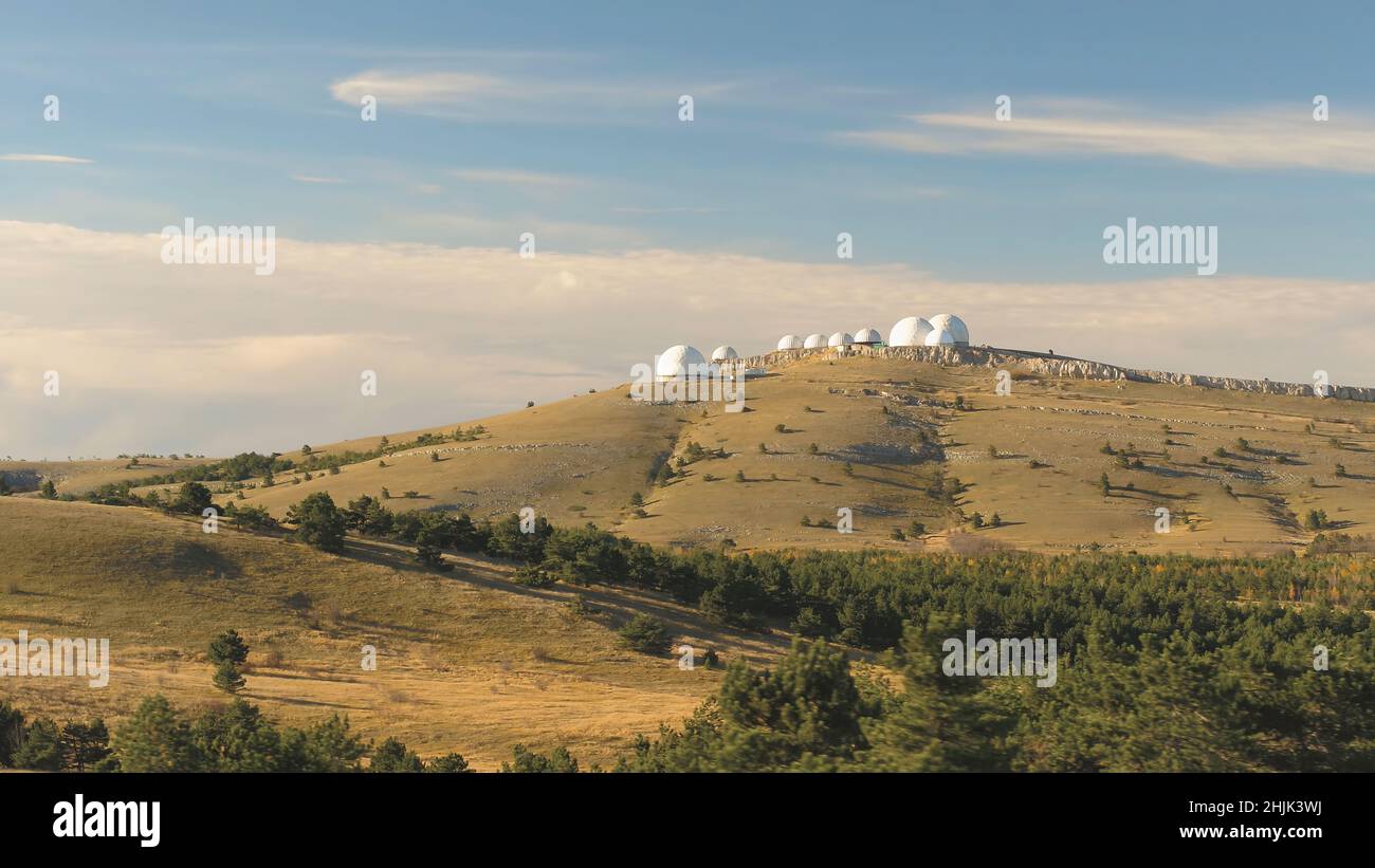 Top view of white domed buildings of observatories on hill. Shot ...