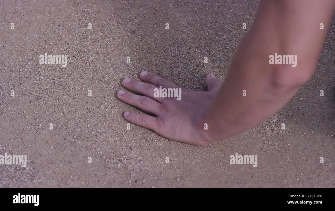 Man's hand touches to their native land. Young man finally home ...