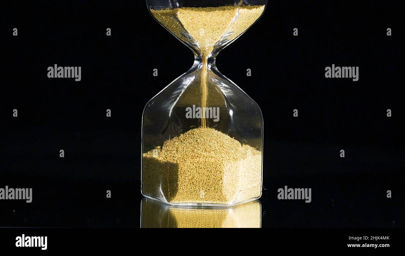 Close-up of golden hourglass. Stock footage. Stylish hexagon hourglass ...