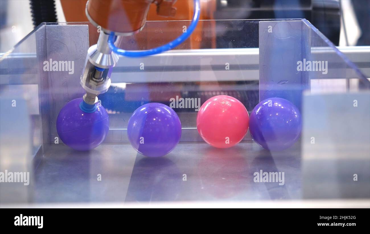 Robot hand machine picking up ball. Media. Use smart robot in ...