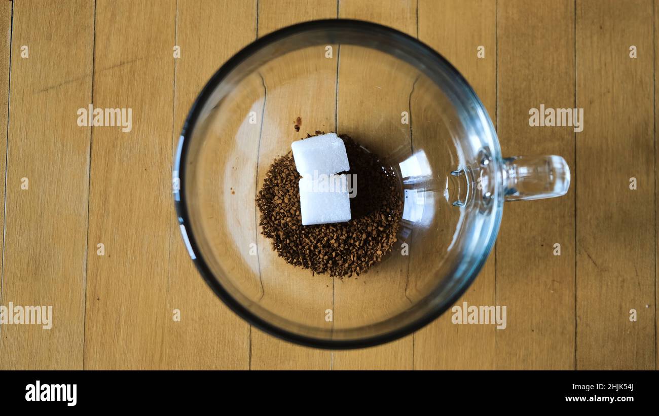 Close-up of process of brewing instant coffee in cup. Concept. Top view ...