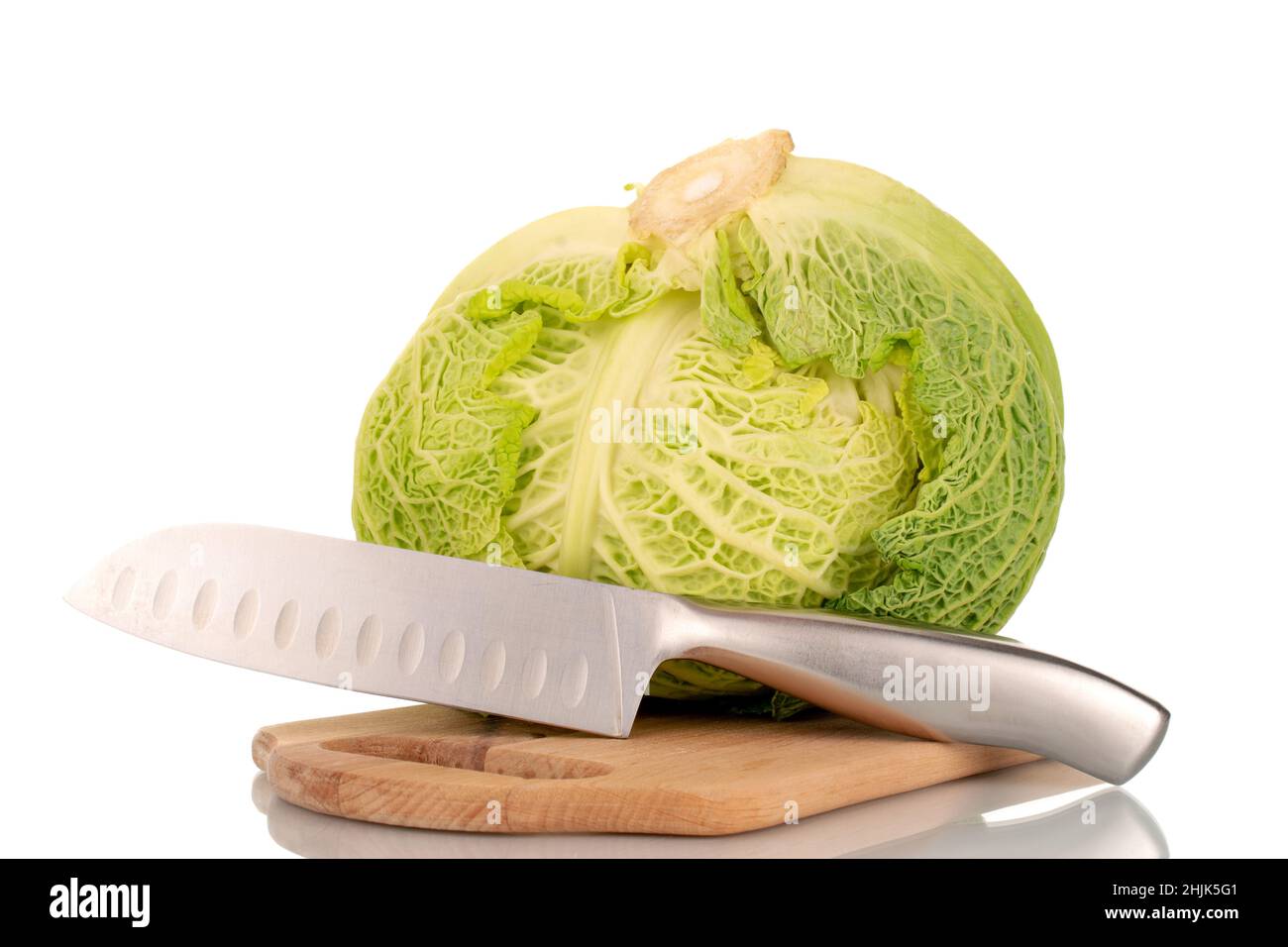 One cabbage of organic Savoy cabbage with a knife on a wooden cutting ...