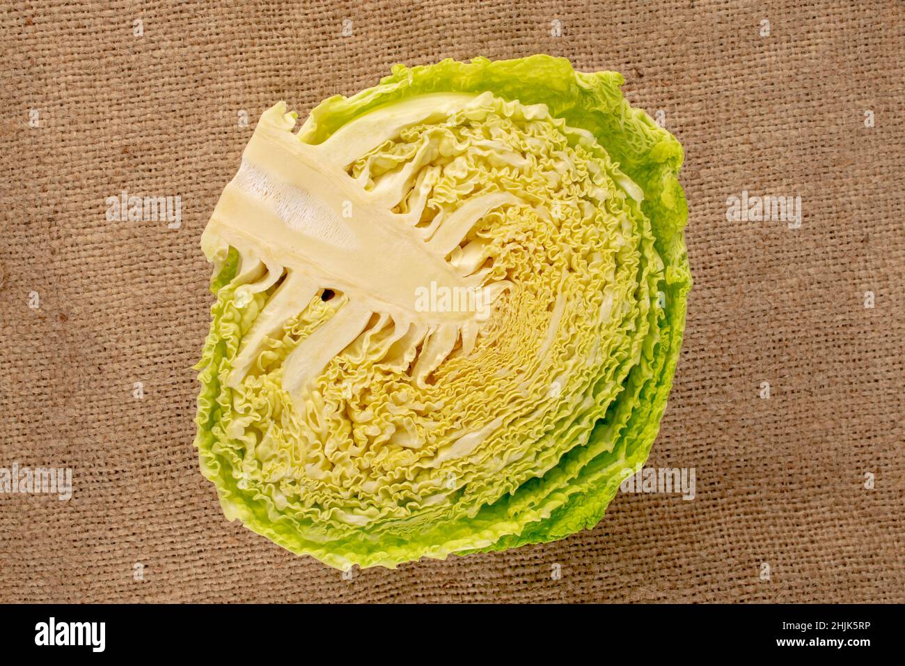 One half of Savoy cabbage on burlap, macro, top view Stock Photo - Alamy