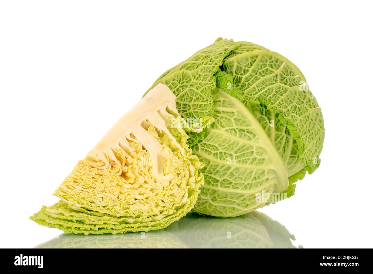One half and one whole organic juicy Savoy cabbage, macro, isolated on ...