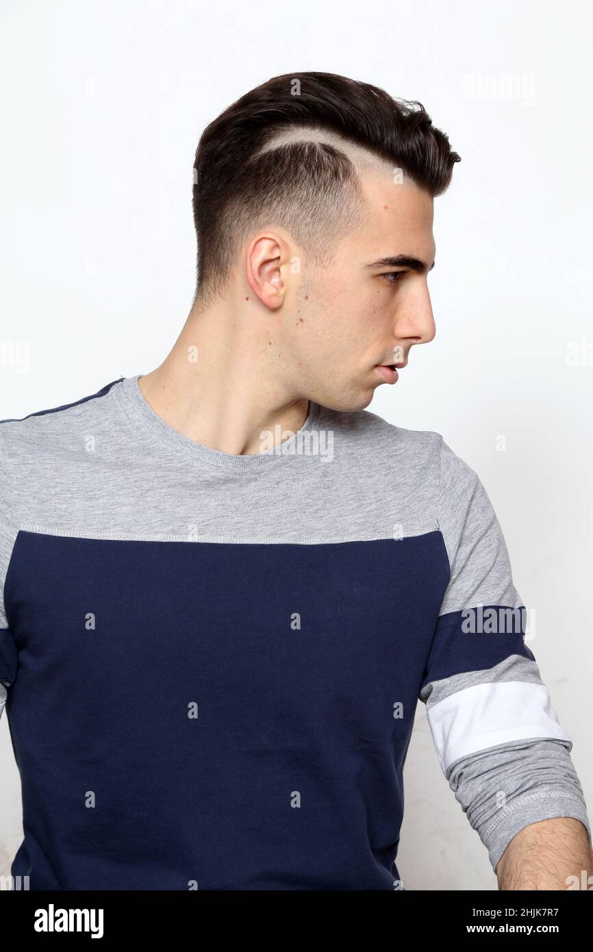 Attractive male model with short hair posing in studio on isolated ...
