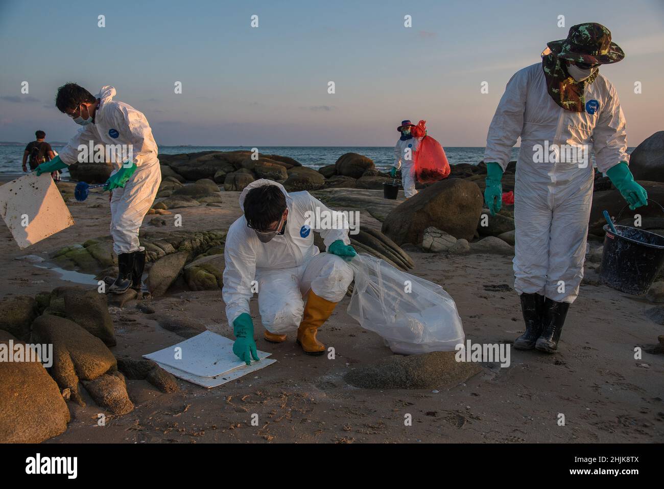 Workers wearing Personal Protective Equipment (PPE) suits are seen ...