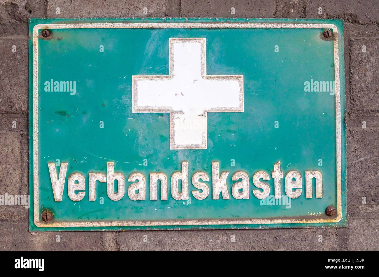 Old signboard rectangular green with a white cross and inscription aid ...