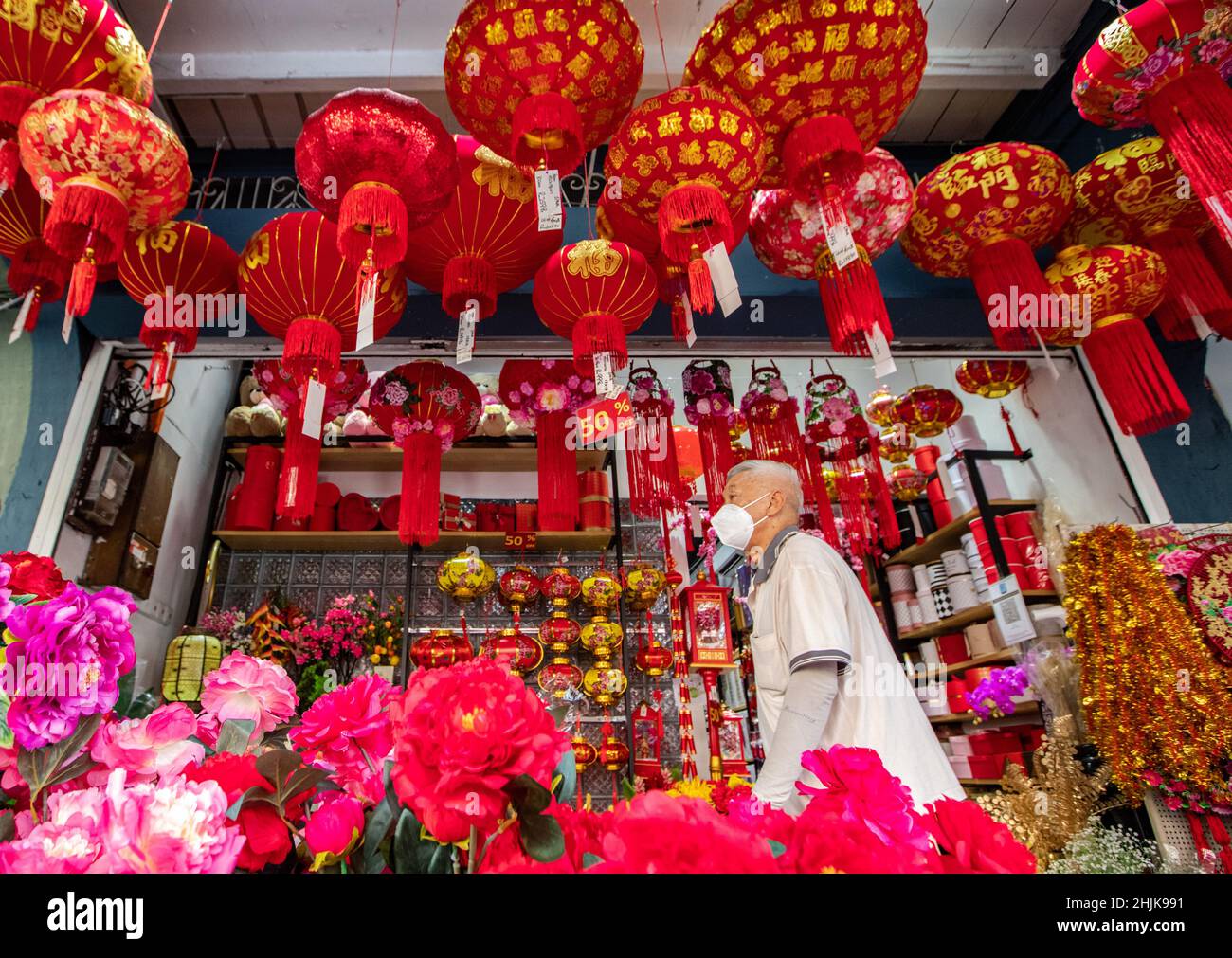 A man shops for Lunar New Year decorations at a shop in the Chinatown ...