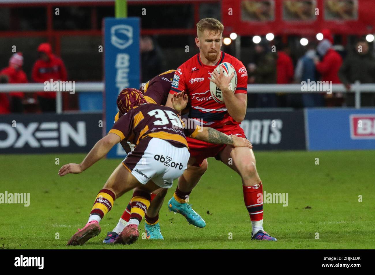 Rowan Milnes (21) of Hull KR runs at the huddersfield defence Stock ...