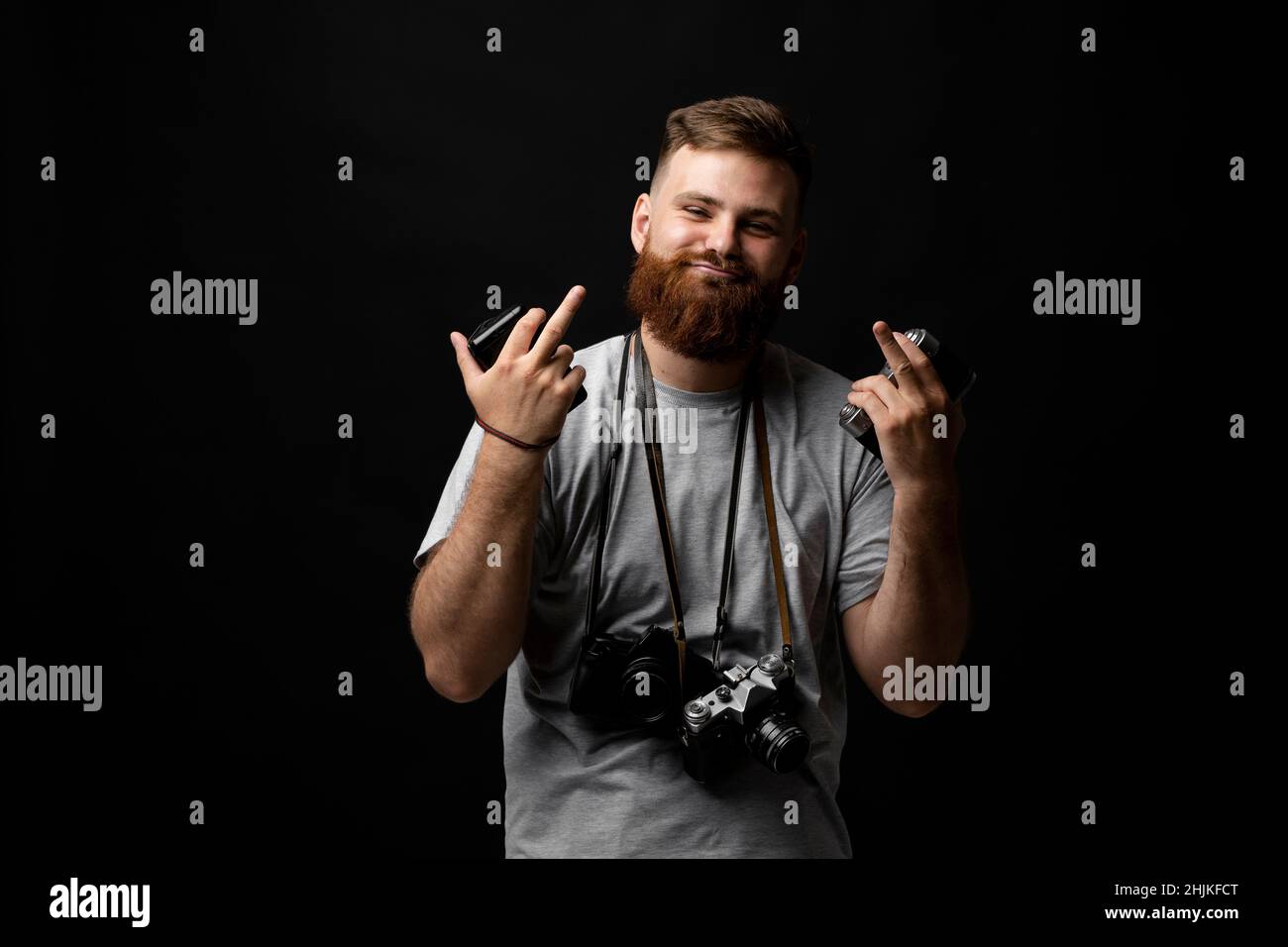 Professional handsome bearded male photographer with bunch of vintage ...