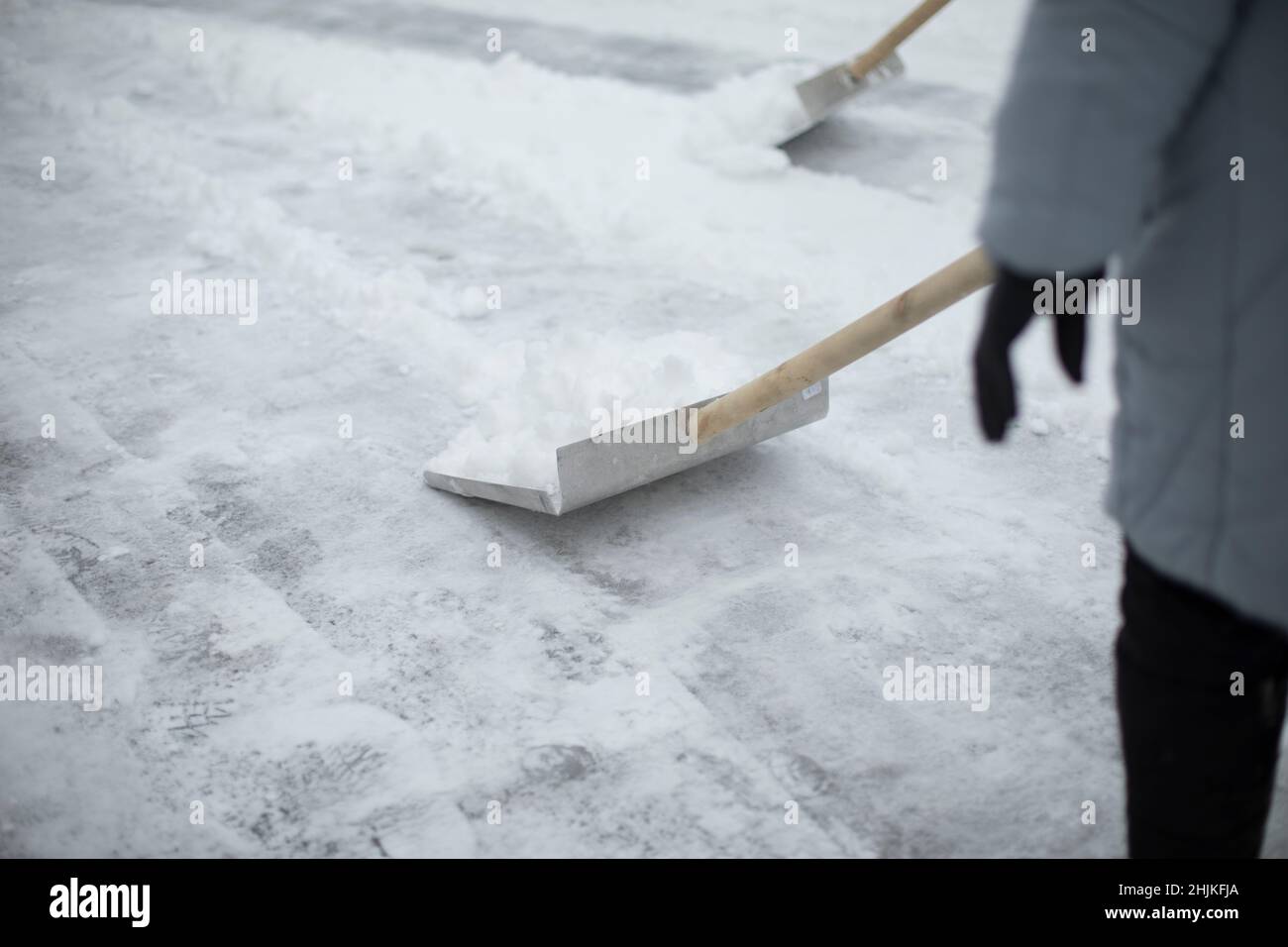 Shovel snow removal. Tool for cleaning snowdrift. Janitor cleans road ...