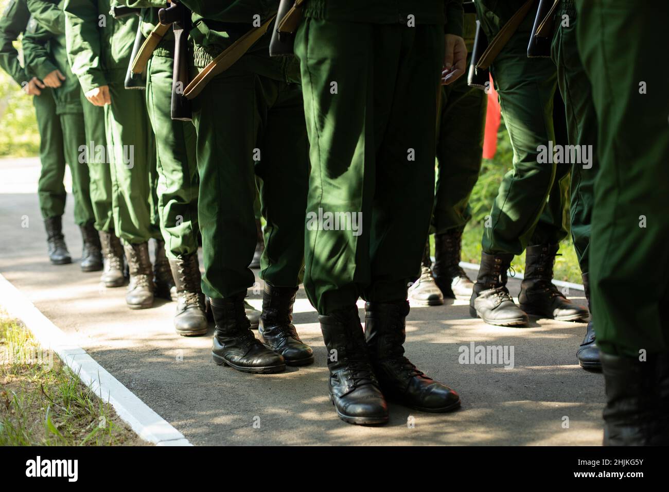 Military stands in row. Soldiers' shoes. Boots and military uniforms ...
