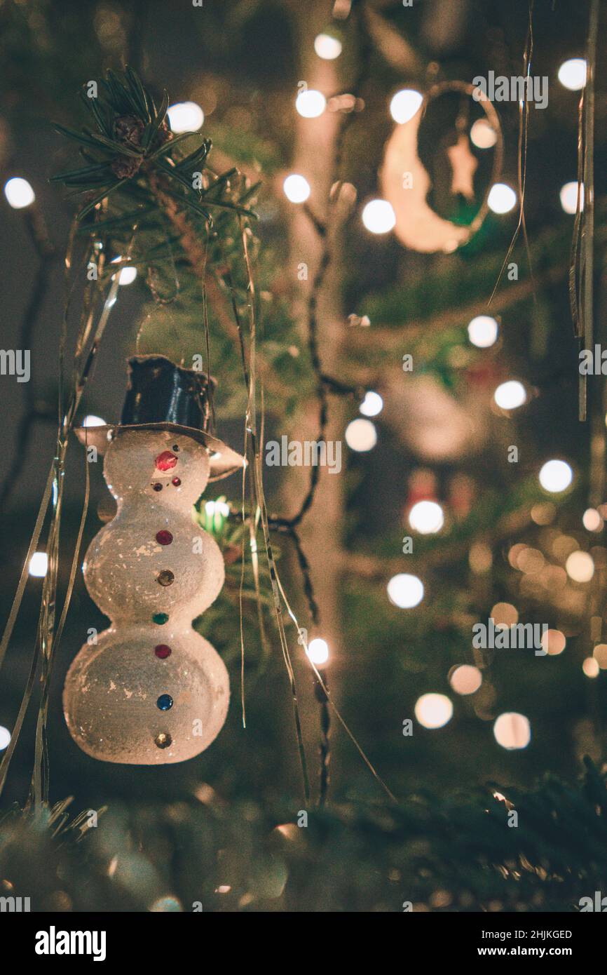 Snowman on decorated tree hi-res stock photography and images - Alamy