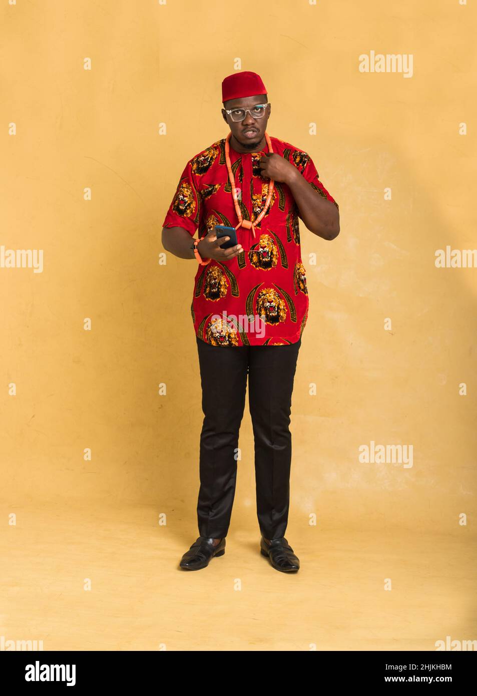 Igbo Traditionally Dressed Business Man Standing with Phone in Hand ...
