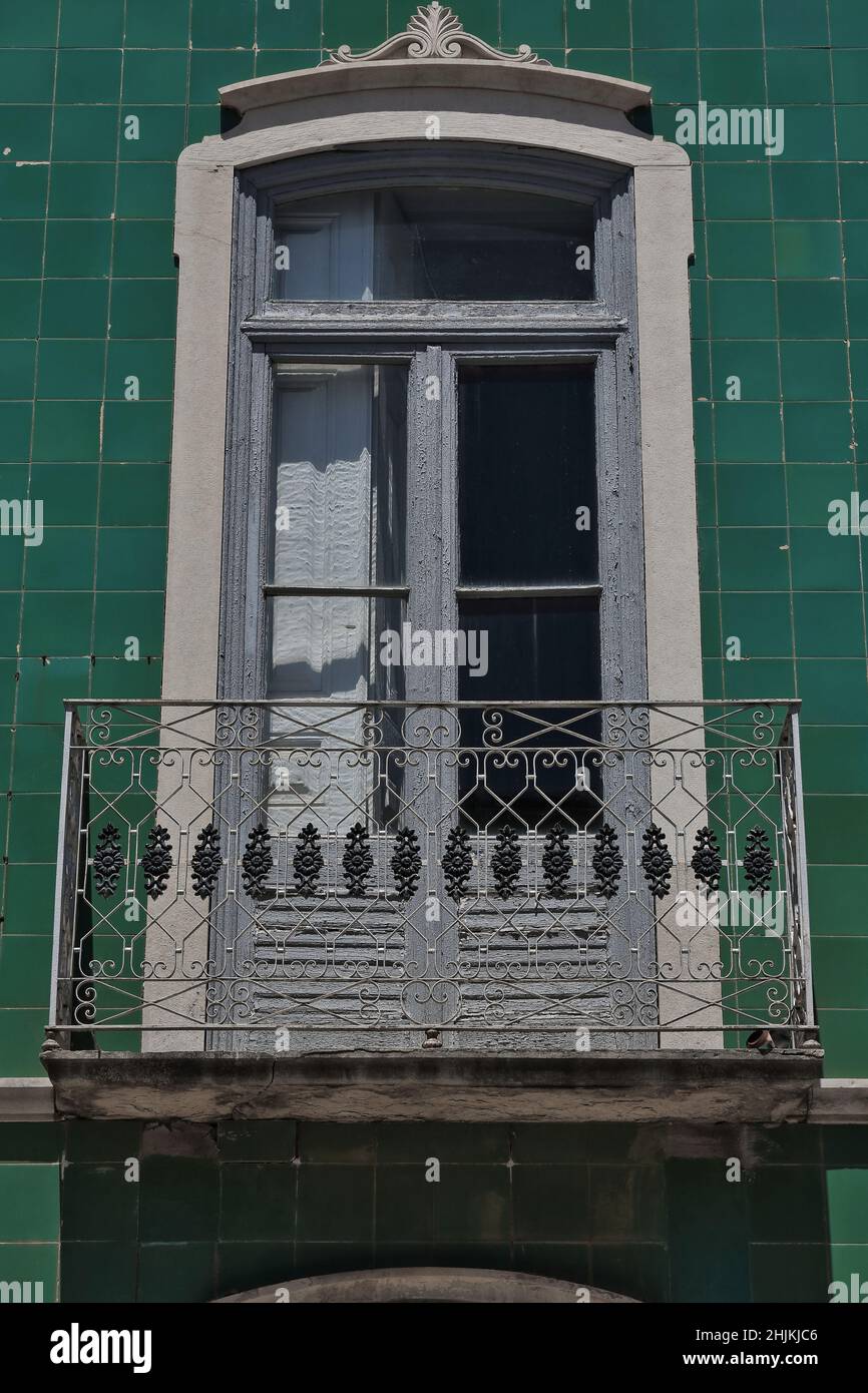 Neoclassical balcony-chipped paint French door-metal railing-green tile ...