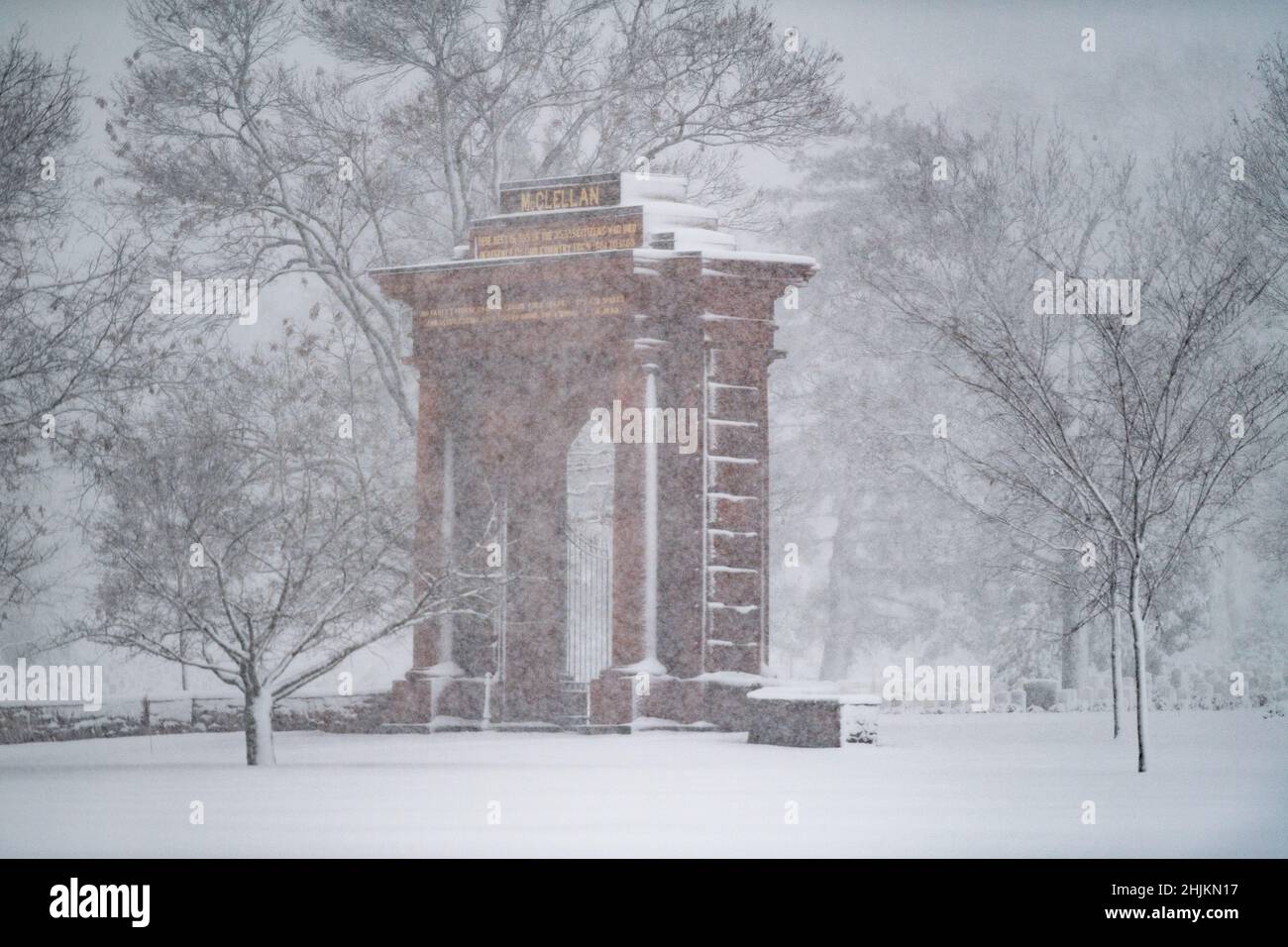 Snow falls near the McClellan Gate at Arlington National Cemetery ...