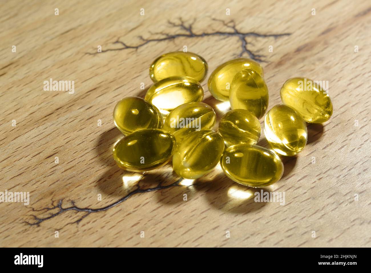 Fish fat cod liver oil omega gel capsules on wooden background Stock ...