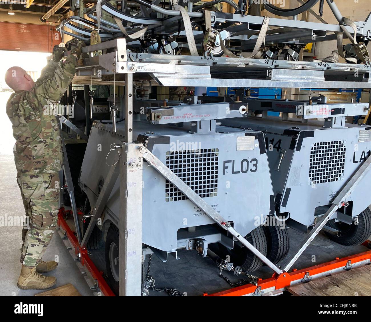 Members of the 147th Attack Wing test a vertical pallet stacking system ...