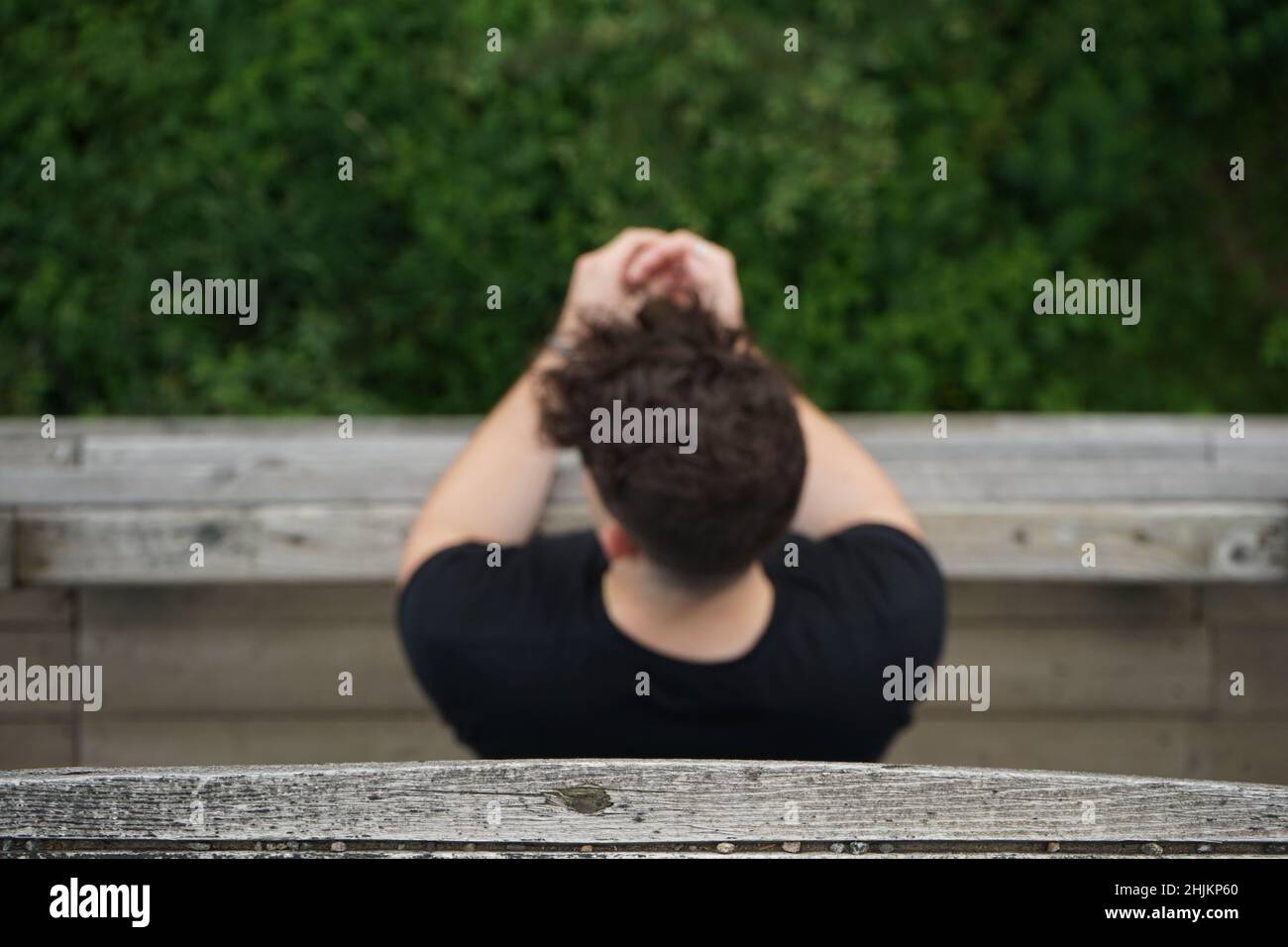 High angle shot of a young man in the balcony looking down Stock Photo ...