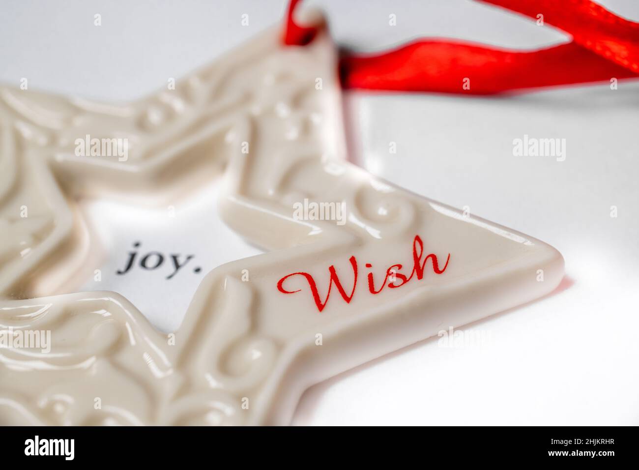joy wish - Christmas ornament with red ribbon on white background Stock ...