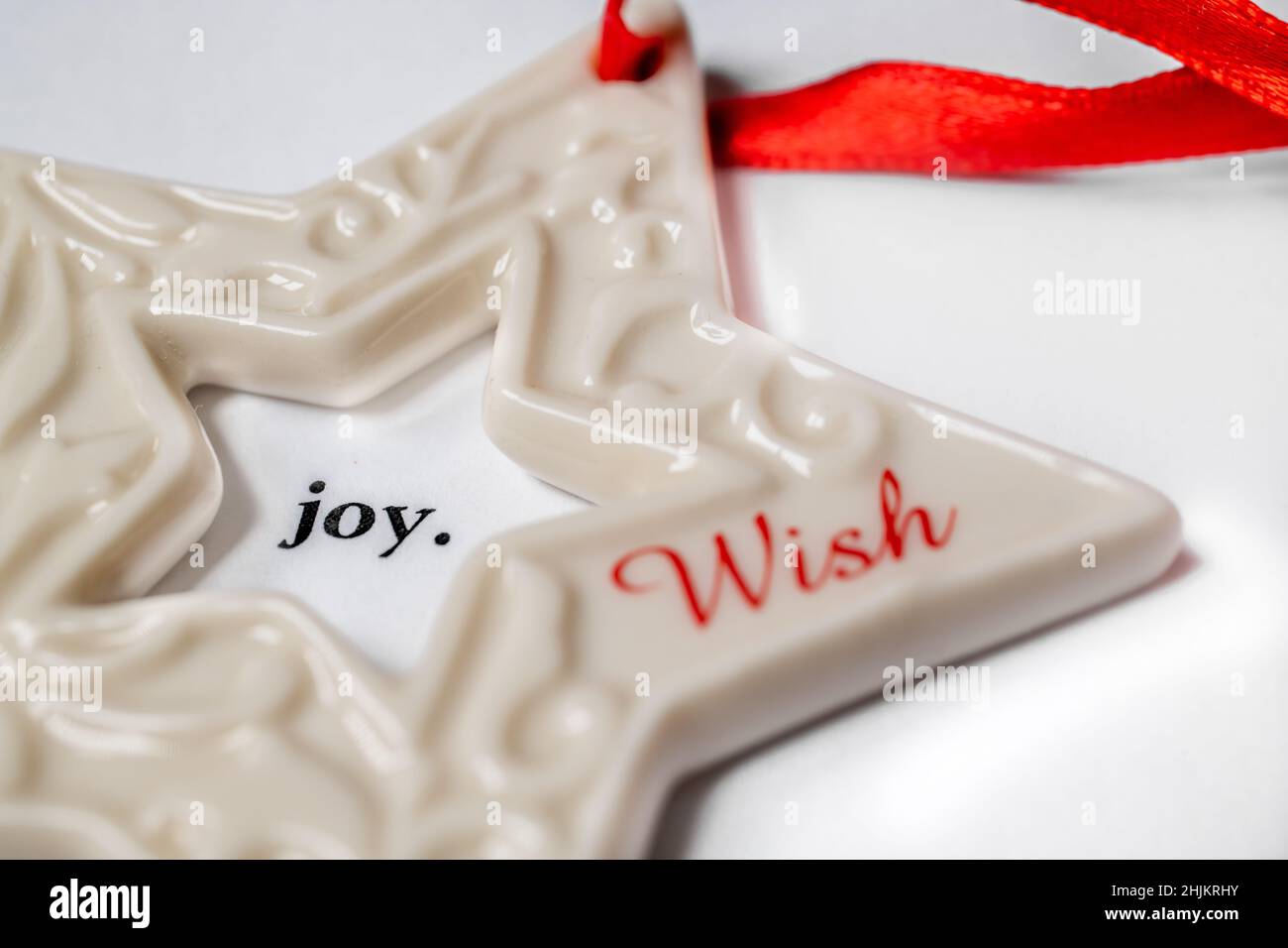 joy wish - Christmas ornament with red ribbon on white background Stock ...
