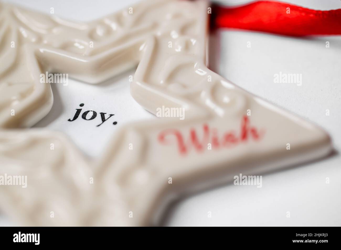 joy wish - Christmas ornament with red ribbon on white background Stock ...