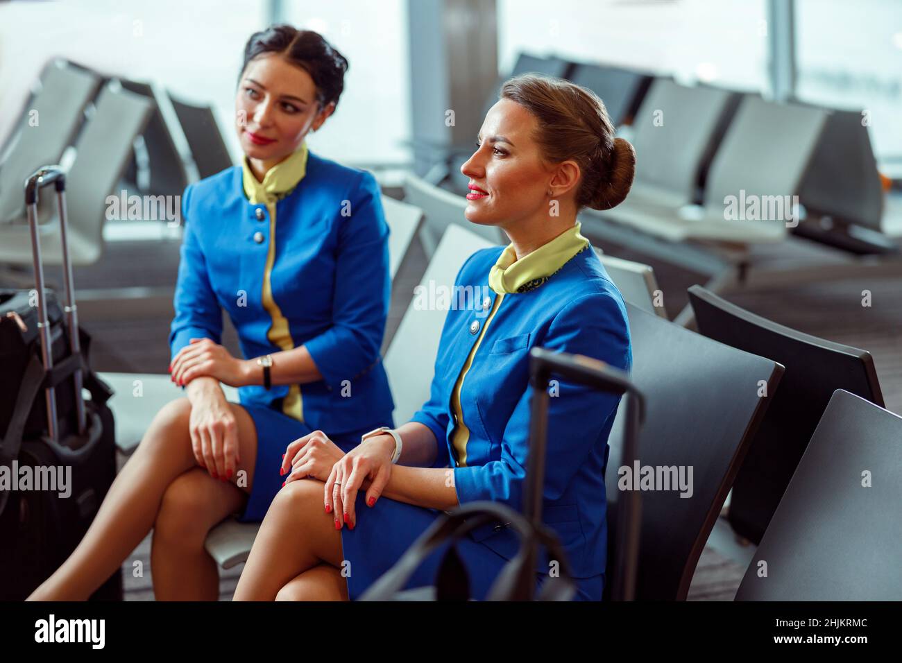 Female flight attendants waiting for the flight at airport Stock Photo ...