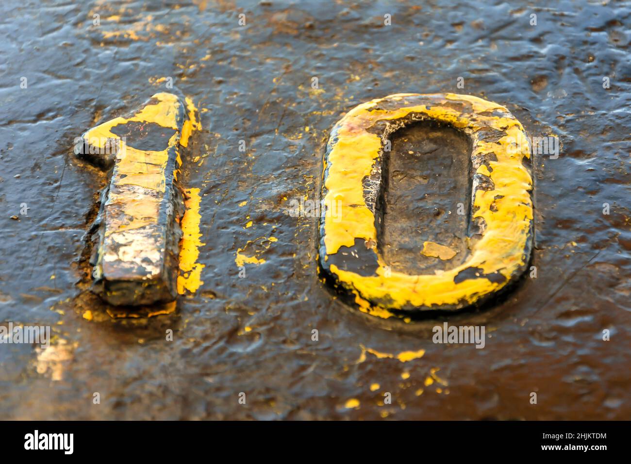 A number ten yellow on a bollard in the dock Stock Photo - Alamy