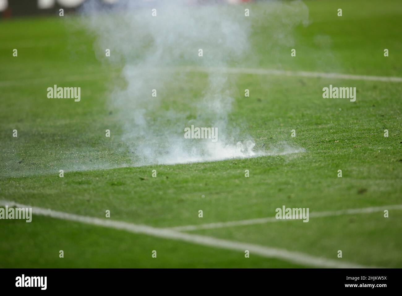 Details with the explosion of a firecracker thrown on the pitch by a ...