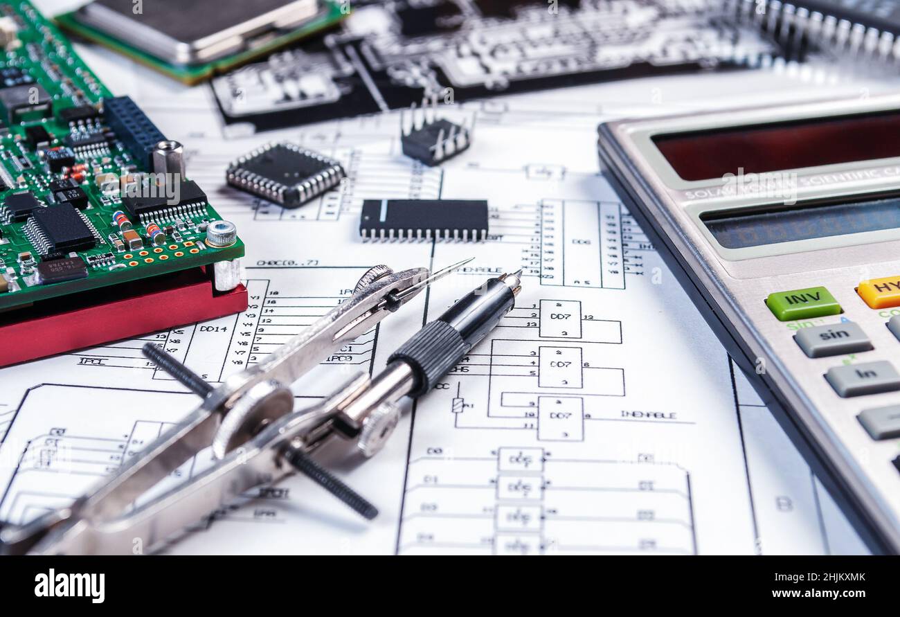 Electronic board, calculator, tweezers and photomask on background of ...