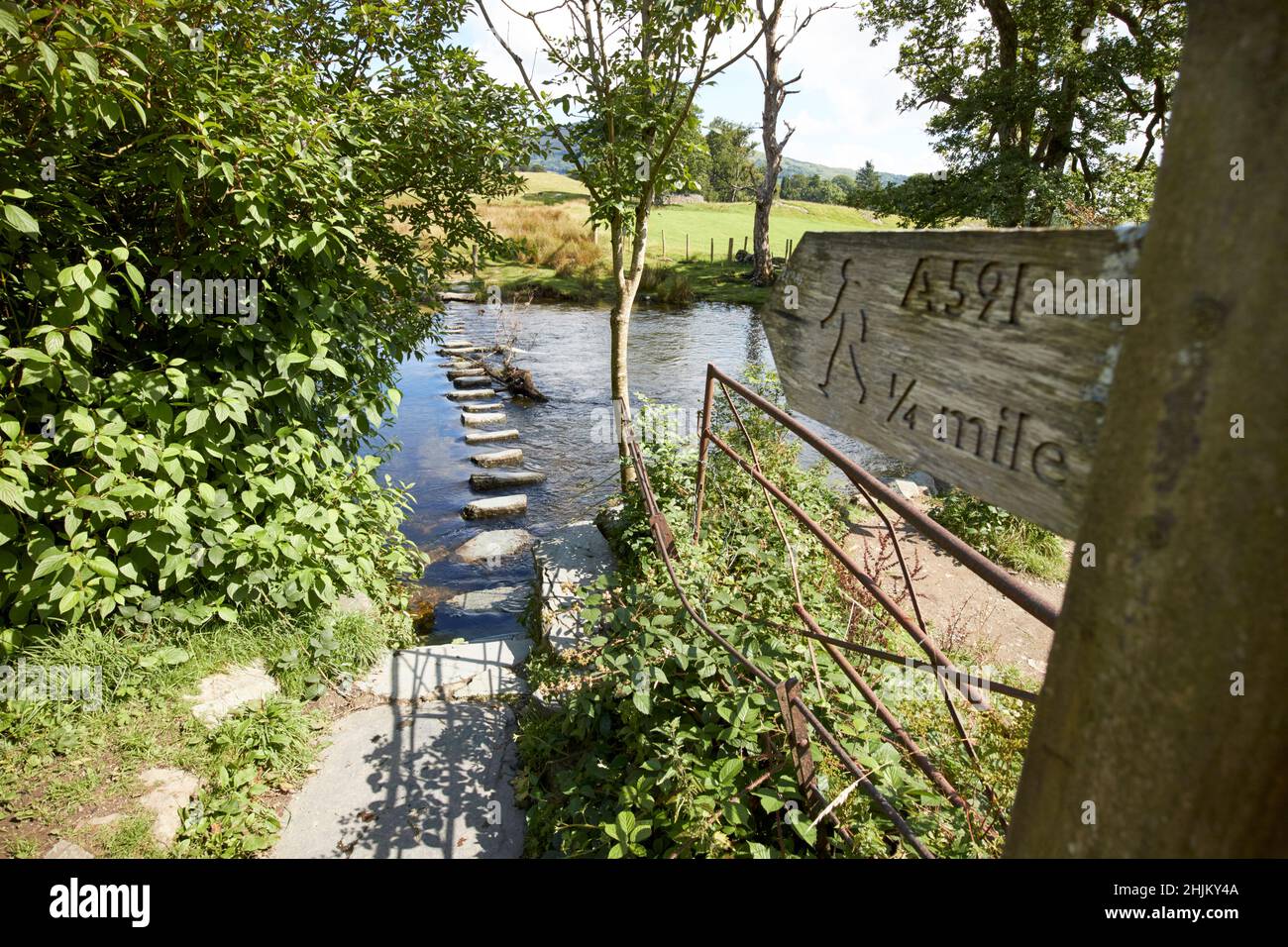 footpath sign and stepping stones across the river rathay flowing ...