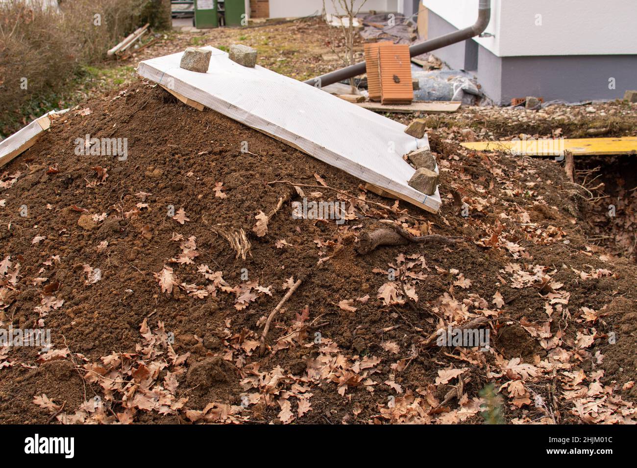Covered mound of earth on a construction site Stock Photo - Alamy