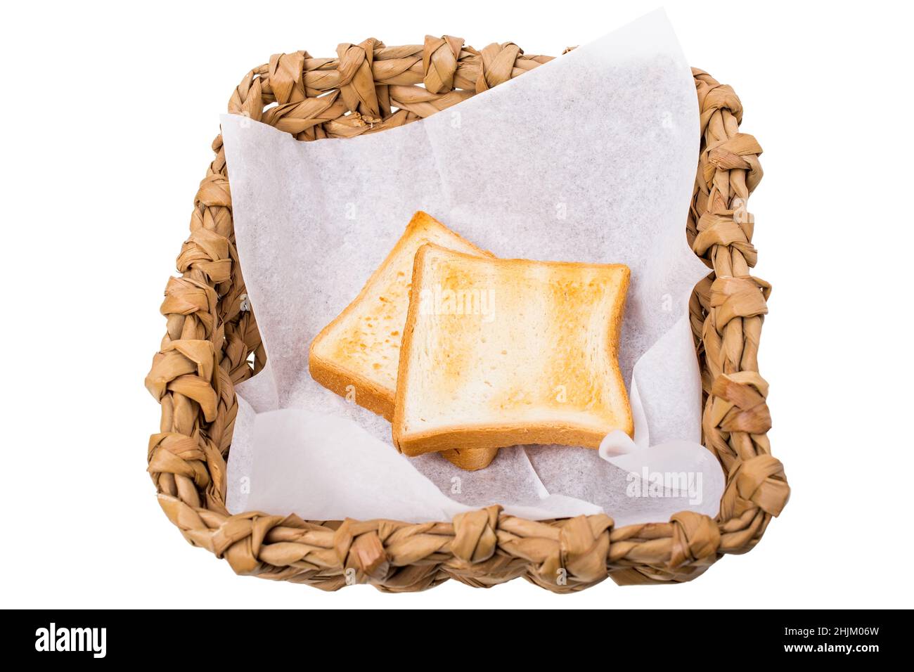 Wicker basket with roasted toasts. Isolated on a white background Stock ...