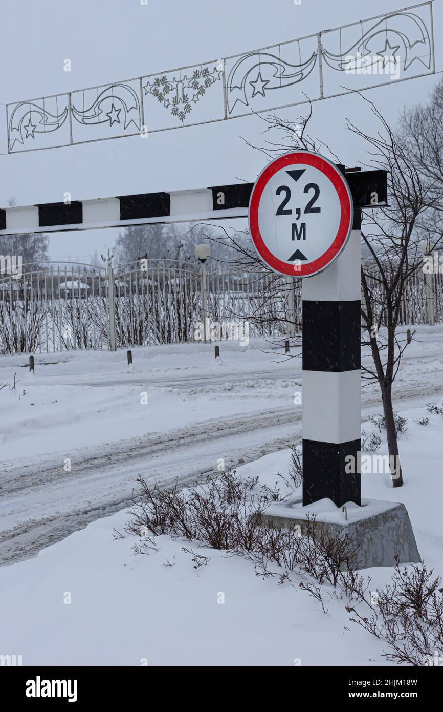 road sign and barrier limiting the height of incoming vehicles. High ...