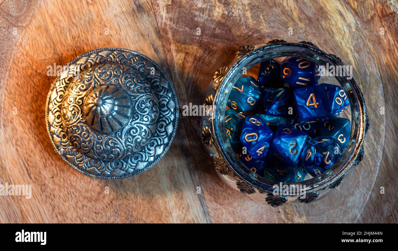 Overhead image of an open ornate glass pot filled with blue role ...