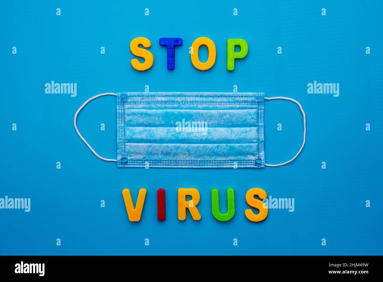 Medical mask and text Stop Virus on blue background. Stop Virus concept ...