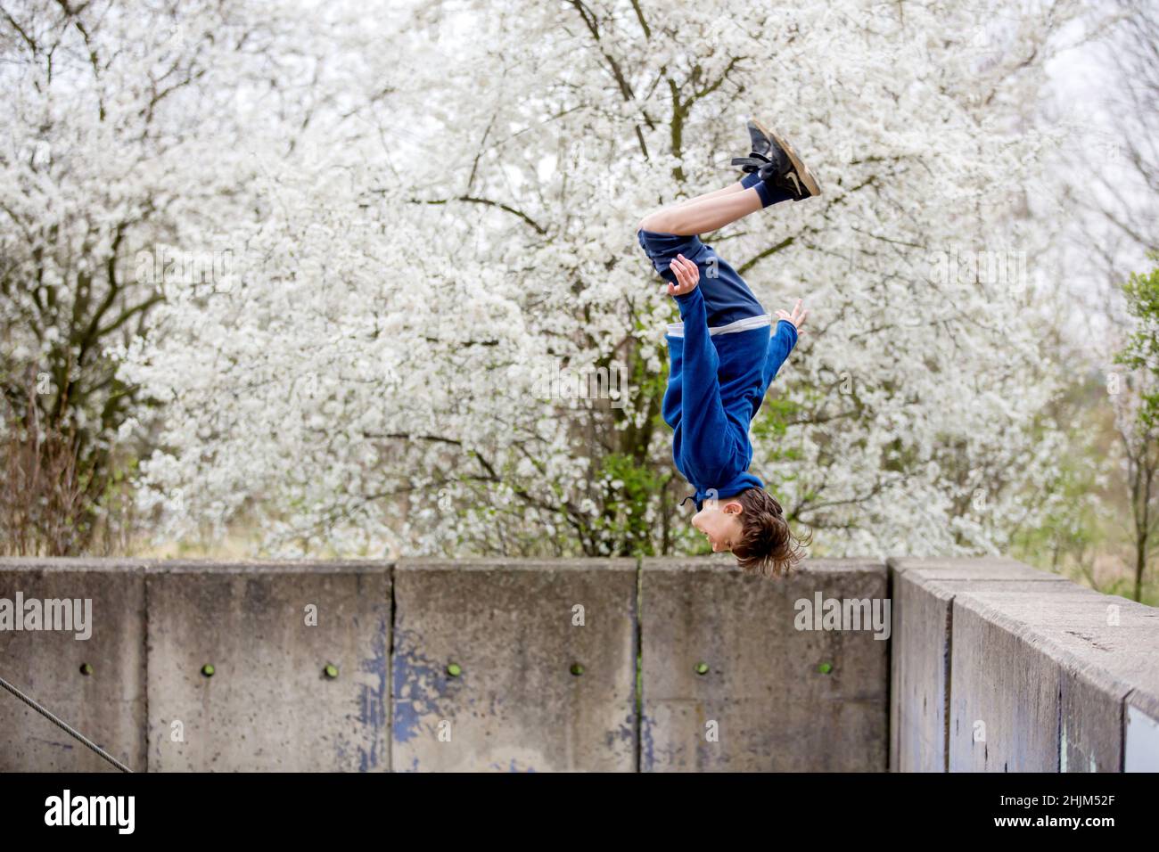Teen child, boy, making summersaults in the park, springtime Stock ...