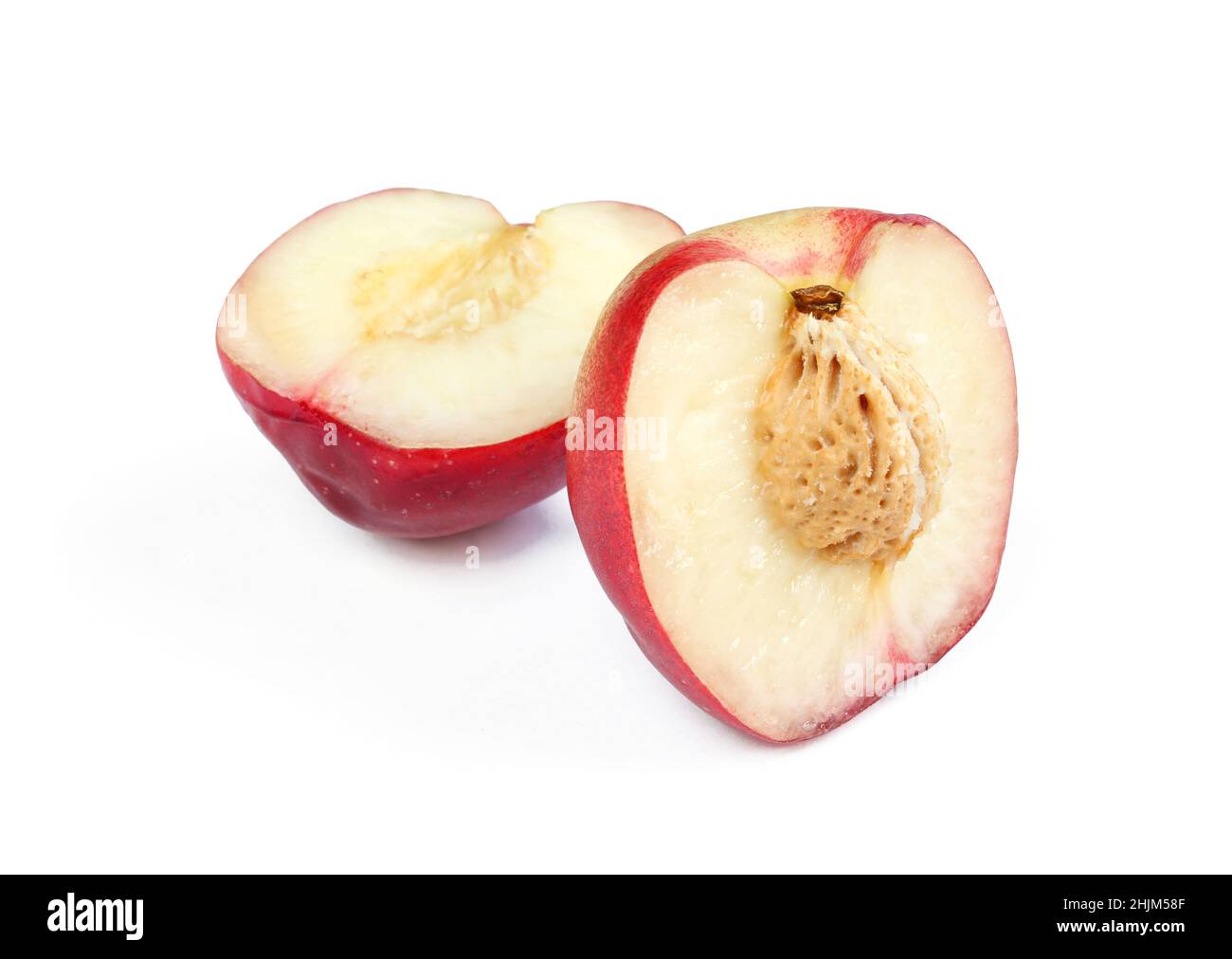 Two parts of sliced nectarine fruit with visible seed isolated on white ...