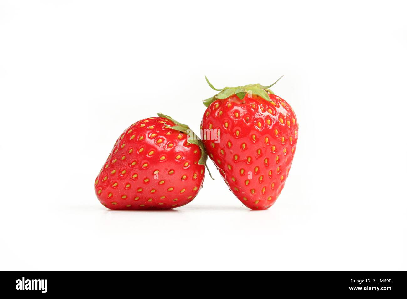 Two shiny strawberries isolated on white background Stock Photo - Alamy