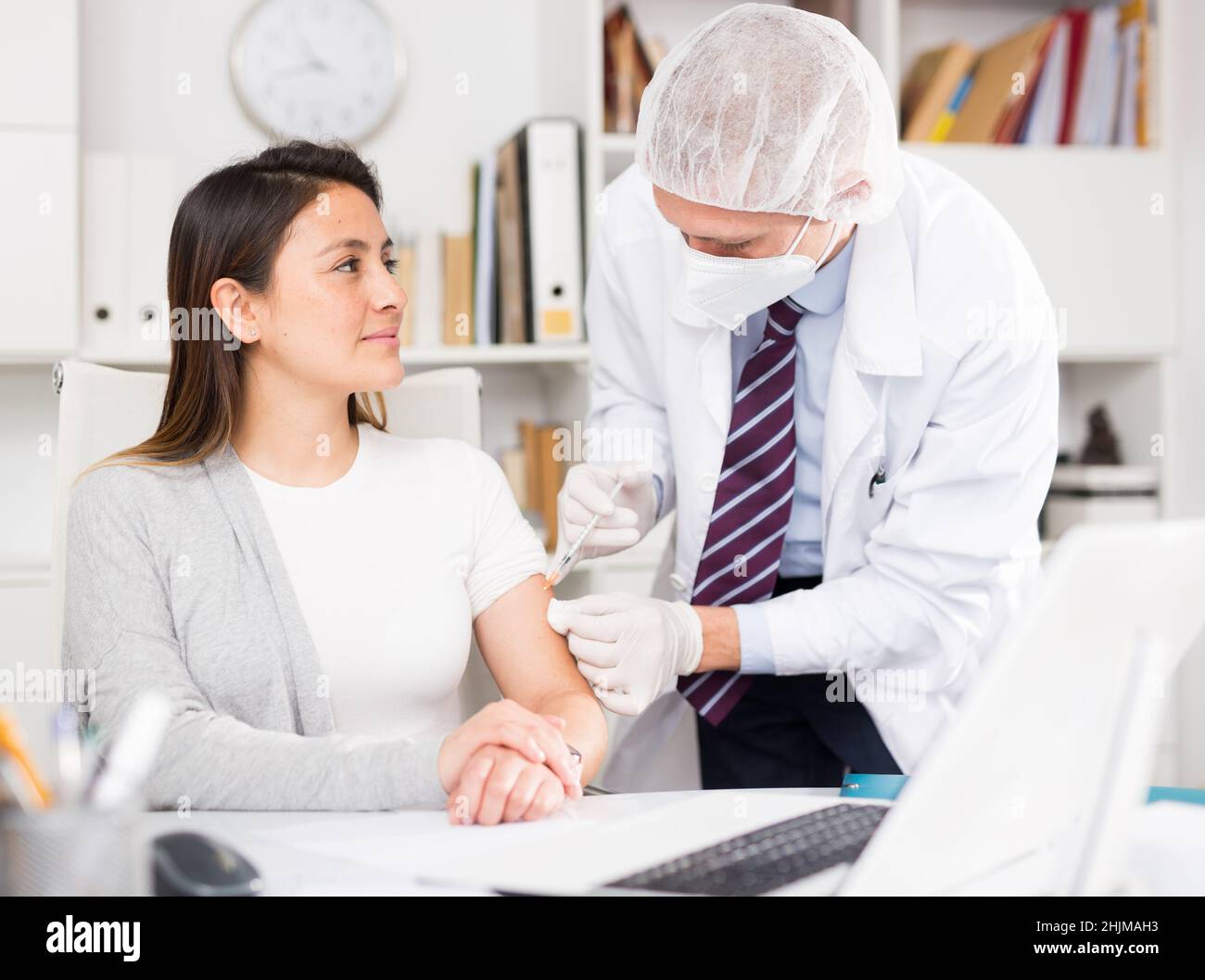 Doctor giving Covid-19 or flu antivirus vaccine shot to patient Stock ...