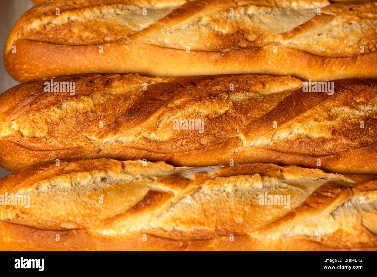 A closeup background of smaller French bread baguettes Stock Photo - Alamy