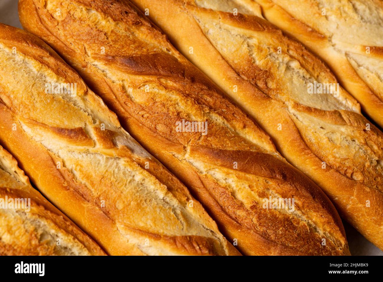 A closeup background of smaller French bread baguettes Stock Photo - Alamy
