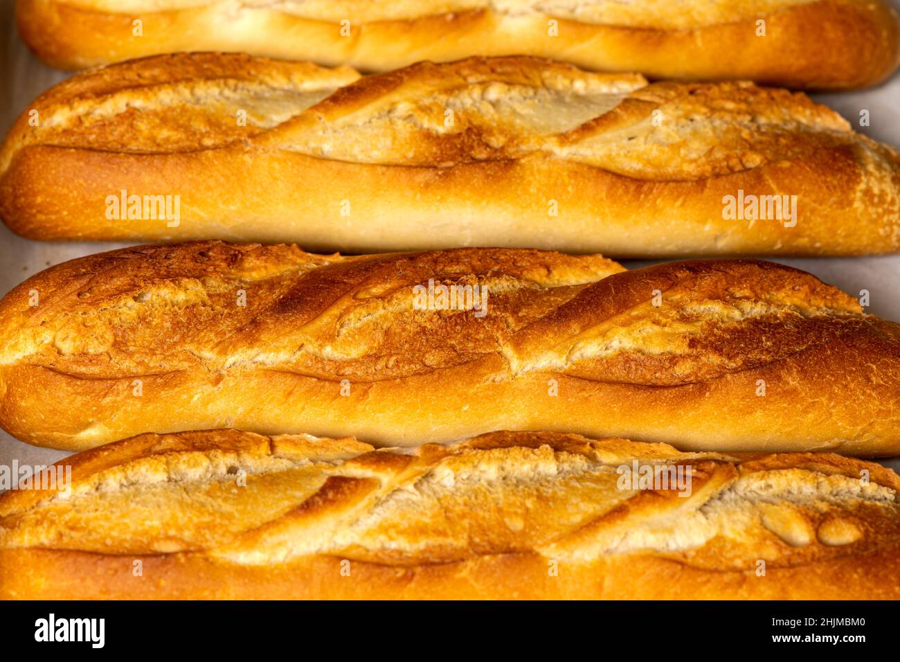 A closeup background of smaller French bread baguettes Stock Photo - Alamy