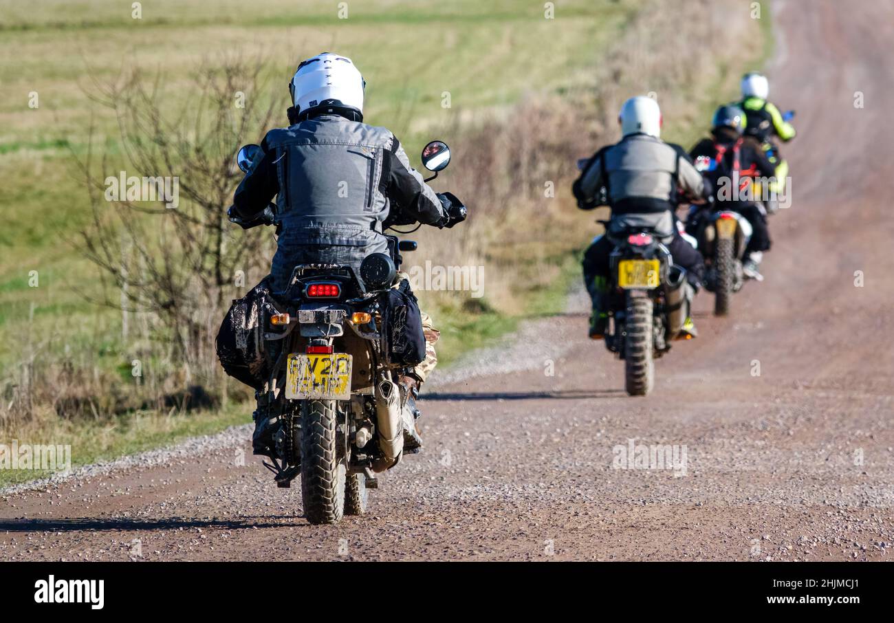 a group of motor cyclists (bikers) riding their off-road motorbikes ...