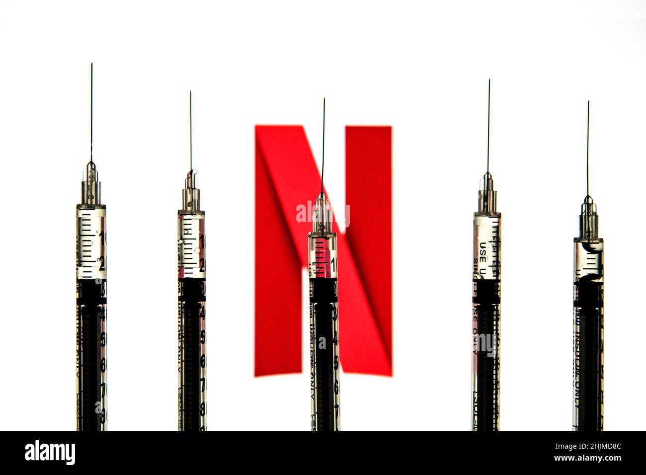 In this photo illustration medical syringes seen with a Netflix logo in ...