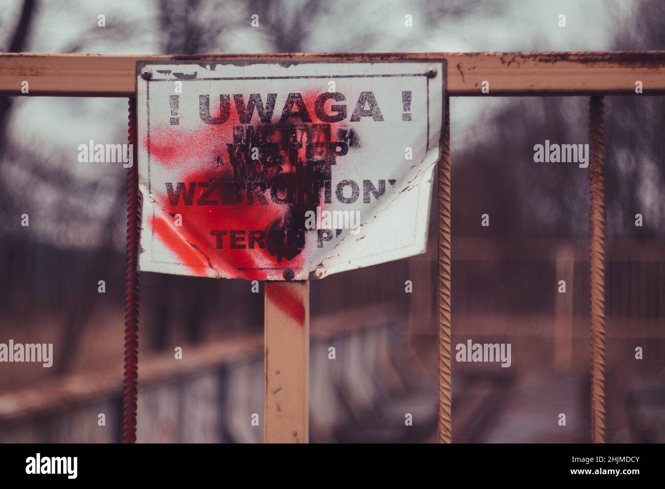 Old damaged caution sign on a rusty fence Stock Photo - Alamy