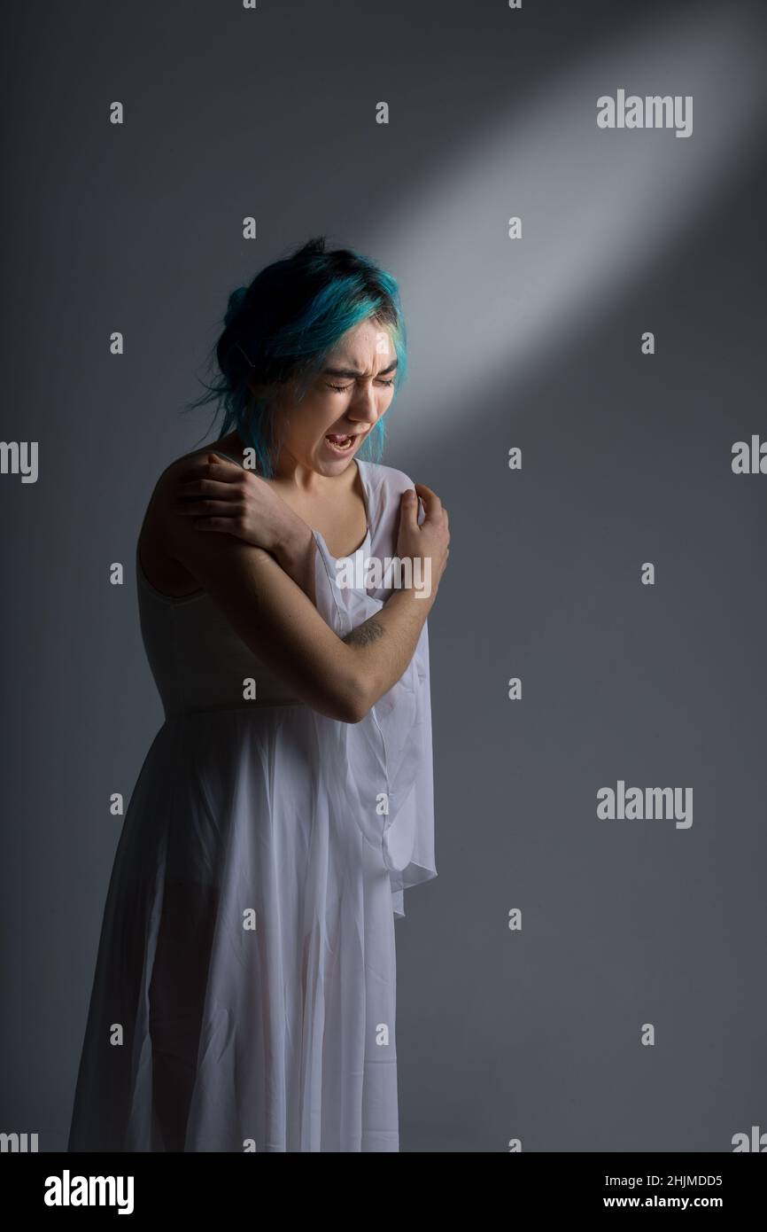 photo of young woman expressing pain and fear Stock Photo - Alamy