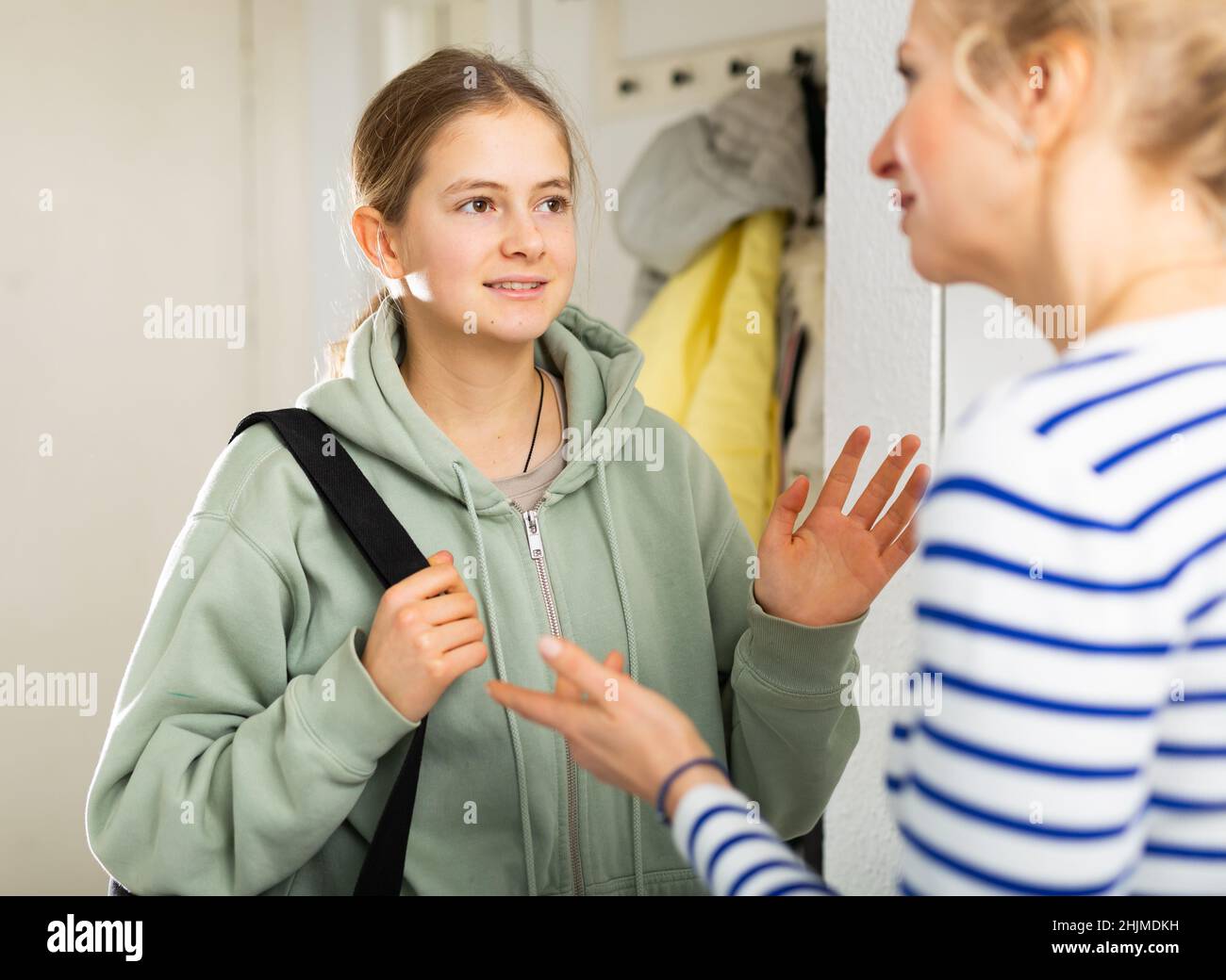 Girl saying goodbye to mother Stock Photo - Alamy