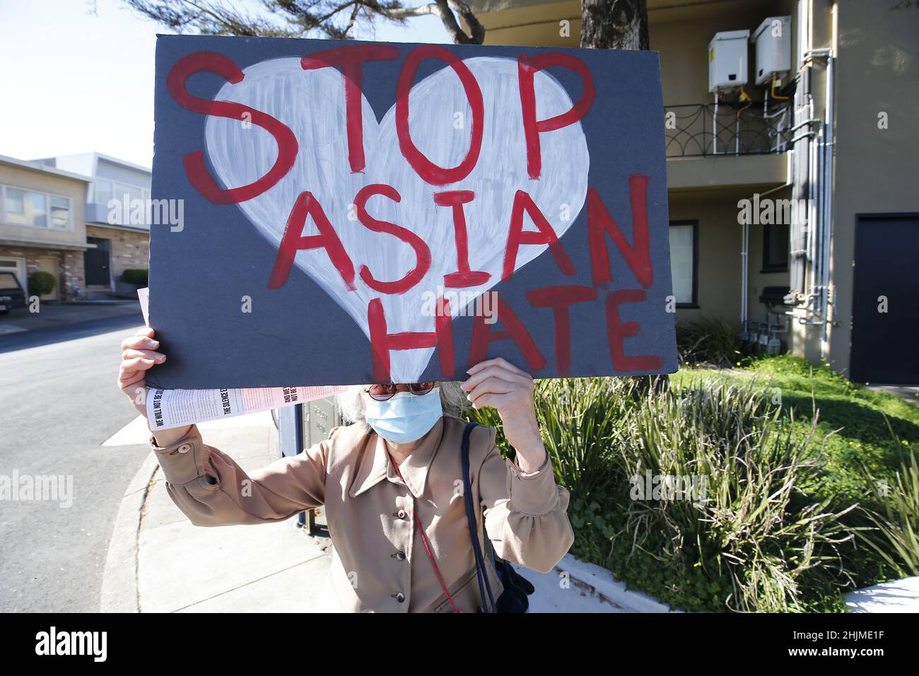 A woman seen holding a placard that says "Stop Asian Hate" during the ...